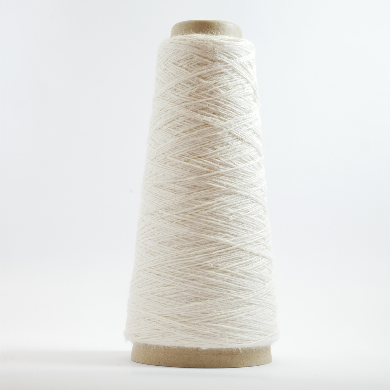 Machine knitting yarn on cones made from eucalyptus trees. | Knit Works ...